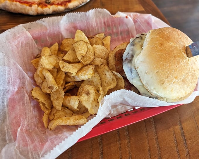 A burger that demands two hands and zero distractions. Those house-made chips aren't sidekicks—they're co-stars in this delicious production. 
