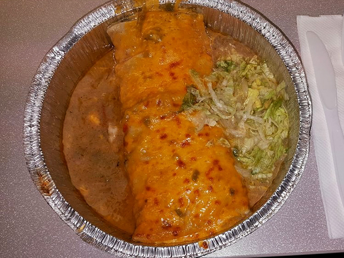 Enchilada-style means drowning in cheese and sauce – exactly how life should be. This aluminum tray holds more joy than most five-star restaurants.