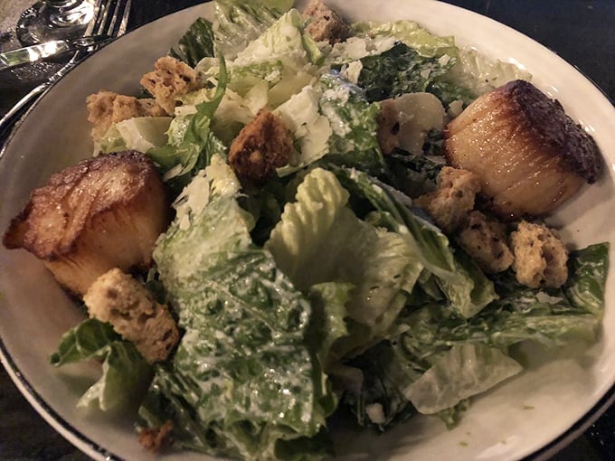 Caesar salad elevated to an art form—those perfectly seared scallops aren't just garnish, they're the supporting actors who steal the scene.