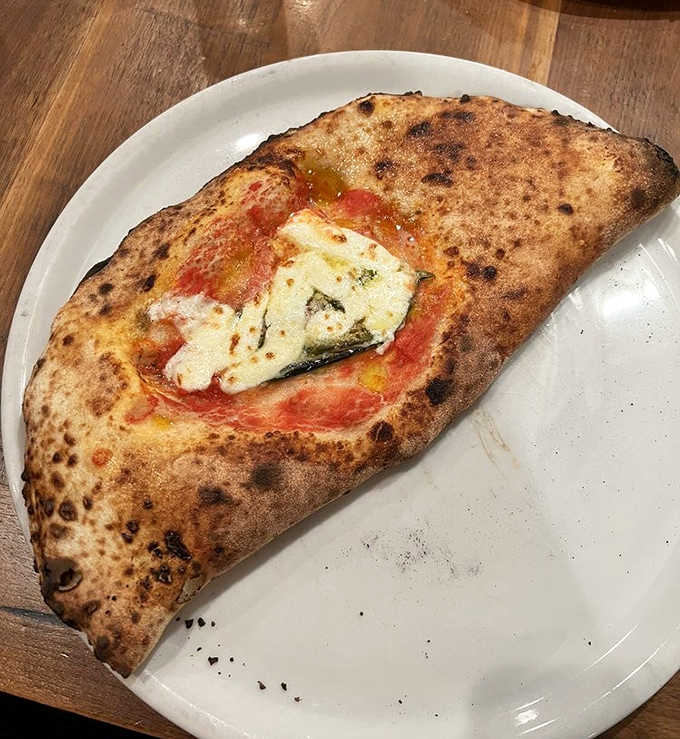 The calzone – pizza's mysterious, folded cousin that somehow manages to pack even more flavor into each heavenly bite.
