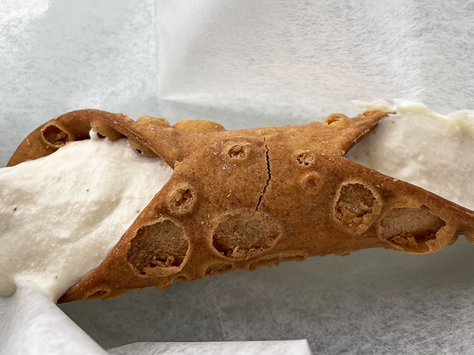 This cannoli isn't just asking to be eaten—it's practically serenading you with promises of crispy shell and creamy filling. Resistance is futile.