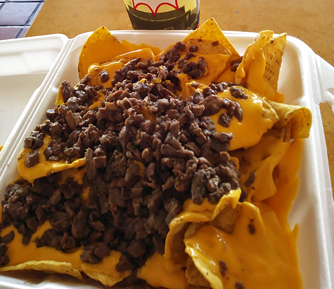 Nachos that laugh at restraint. That cheese-to-meat ratio isn't just generous—it's downright philanthropic.