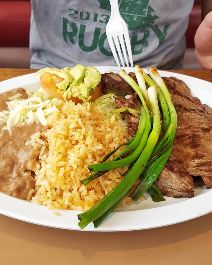Carne asada done right is poetry on a plate. The green onions aren't just garnish—they're the exclamation point on a meaty masterpiece.