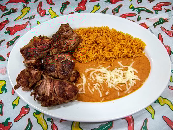 Carnitas so tender they practically surrender at the touch of your fork, served with that perfect trio of Mexican rice, beans, and melty cheese.