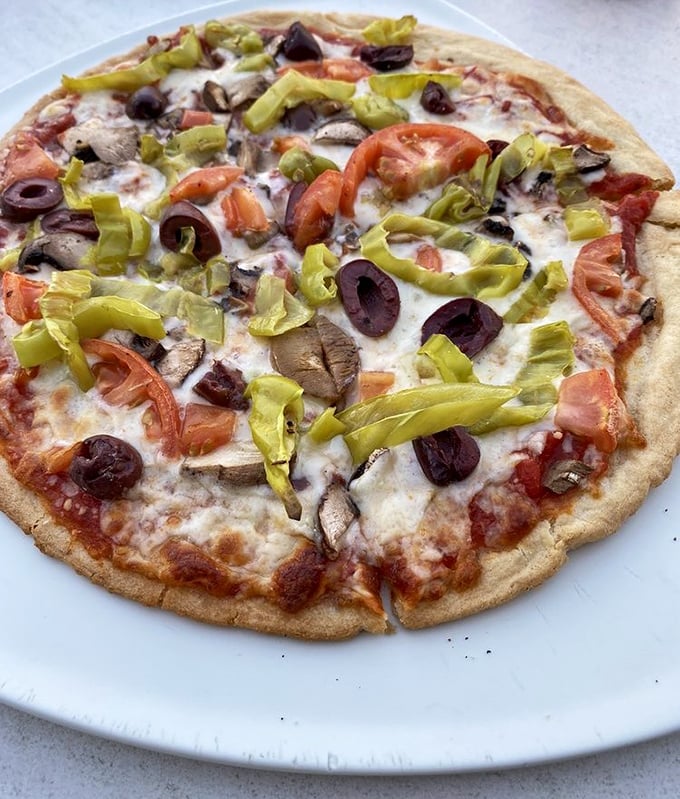 A veggie-lover's dream that proves pizza toppings are like supporting actors—sometimes the mushrooms, olives, and peppers deserve their own standing ovation.