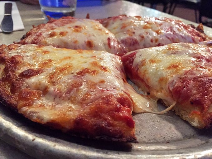 Pizza perfection isn't complicated—it's this gloriously simple cheese pie with edges that curl up just enough to create those magical little oil reservoirs.