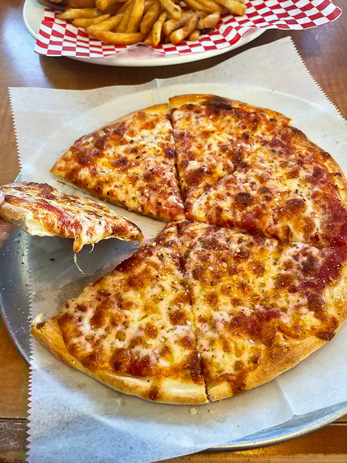 Pizza that doesn't pretend to be anything but exactly what you want—cheese melted to golden perfection on a crust that means business.