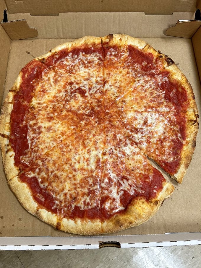 The classic cheese pizza—the benchmark of any great pizzeria. That perfect ratio of sauce to cheese with a crust that's neither too thick nor too thin.