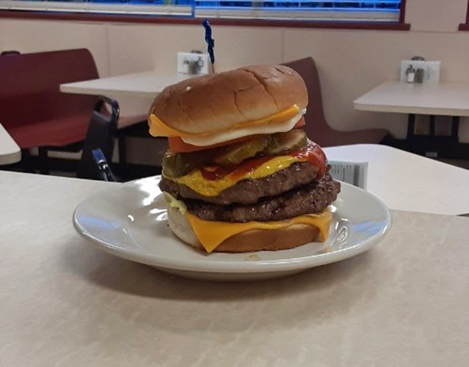 This isn't just a burger—it's a skyscraper of beef that requires jaw exercises before attempting. Structural engineering meets comfort food in the most delicious way possible.