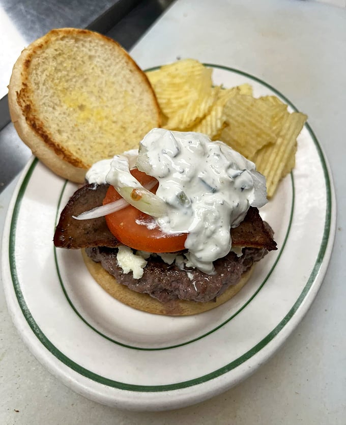 This isn't some fancy gastropub creation—it's a proper diner burger with all the fixings and zero pretension. The cream sauce adds that special touch.