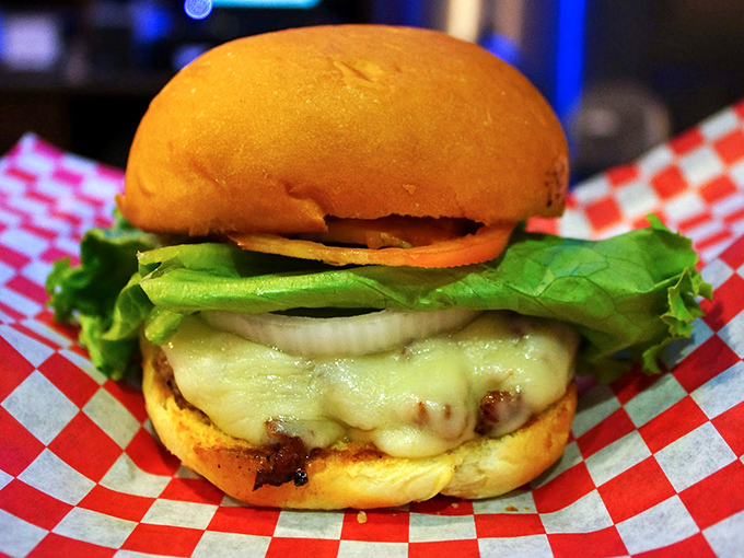 A perfect burger isn't just food—it's architecture. This masterpiece balances melty cheese, fresh veggies, and a golden bun in perfect harmony.