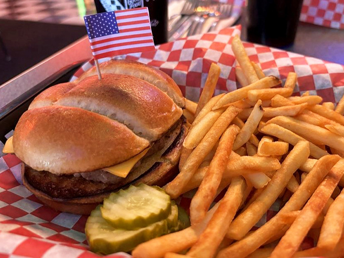 This isn't just a cheeseburger; it's America on a plate, complete with a tiny flag that says "Yes, this is exactly what you've been craving."
