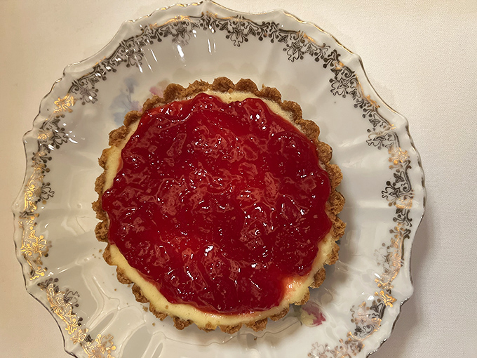 A ruby-red cranberry tart that balances sweet and tart like a culinary tightrope walker. The delicate pastry crust cradles its jewel-toned filling with the care of a museum curator.