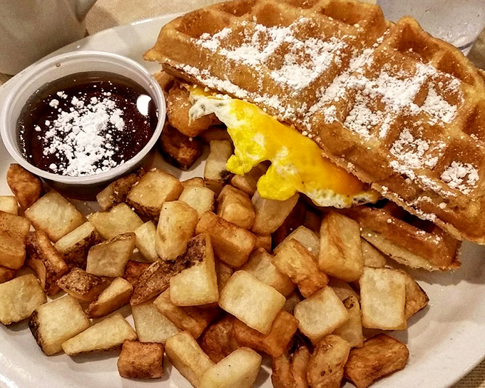 The chicken and waffle situation here isn't just breakfast – it's architecture, sculpture, and poetry, dusted with powdered sugar for good measure. 