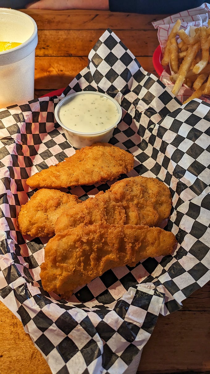 Golden-fried chicken tenders that shatter with each bite, paired with fries that clearly didn't come from a freezer bag. This is comfort food elevated.