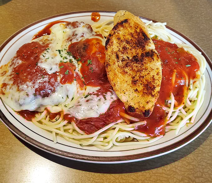 Spaghetti, sauce, cheese, and garlic bread—this chicken parmesan isn't trying to reinvent Italian-American cuisine, it's just perfecting it.