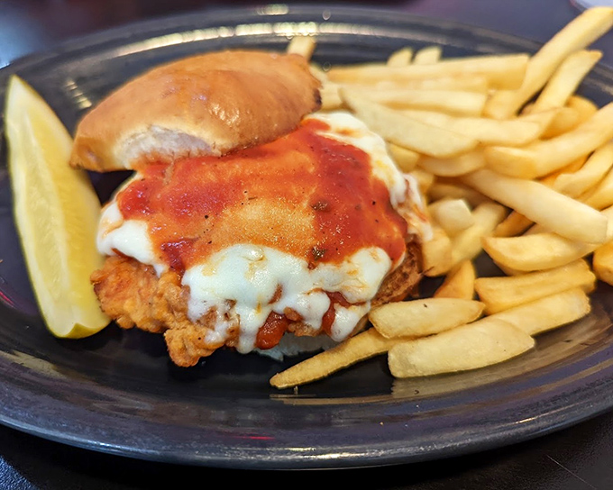 The Chicken Parmesan Sandwich—where Italian tradition meets American diner ingenuity. Crispy, saucy, cheesy perfection with a side of golden fries.