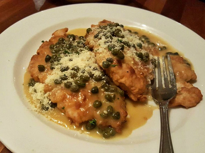 Chicken piccata that's having a love affair with capers and lemon butter sauce. The fork is there as a formality—you'll want to drink this.
