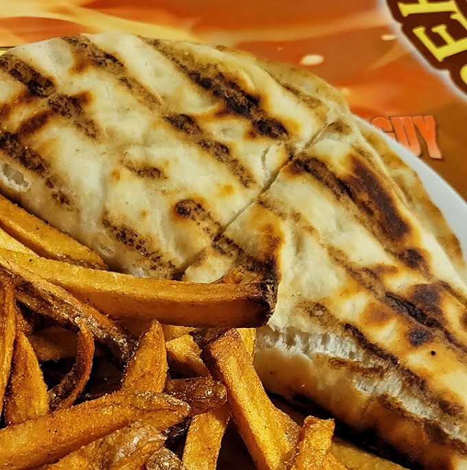 Perfectly grilled flatbread cradles melted cheese and chicken in a warm embrace. The grill marks aren't just decoration—they're flavor tattoos.