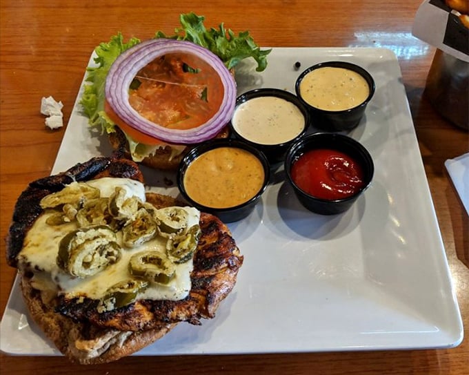 This isn't just a chicken sandwich; it's a masterclass in toppings with jalapeños, melted cheese, and a lineup of sauces that deserve their own fan club.