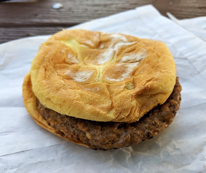 No fancy brioche buns or artisanal aioli here—just an honest burger that tastes like summer afternoons and zero pretension.