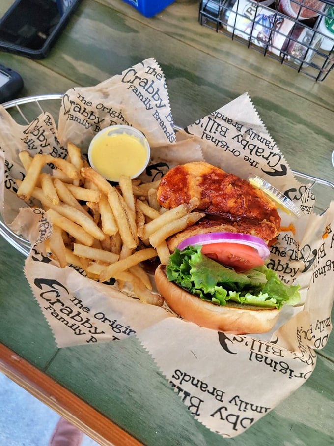 The blackened grouper sandwich—Florida's unofficial state handshake—arrives wrapped in paper like the delicious gift from the Gulf that it is.