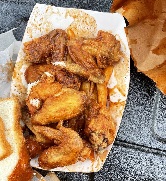 Golden-fried wings and sauce-drenched tips share space in perfect harmony—like a delicious jazz duet on a paper plate.