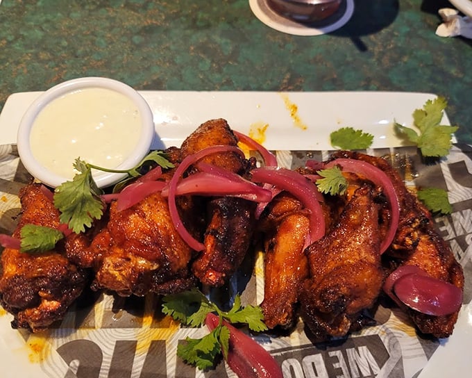These wings aren't just smoked, they're having a flavor party with pickled onions and fresh cilantro – proof that barbecue joints can be surprisingly sophisticated when they want to be.