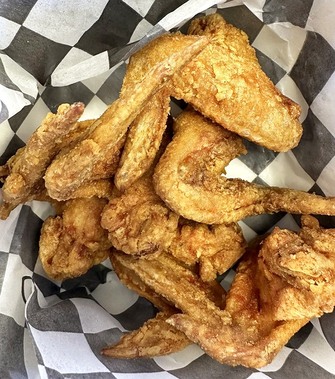 These golden-fried wings aren't just crispy—they're the kind of crispy that makes you involuntarily close your eyes with each bite.