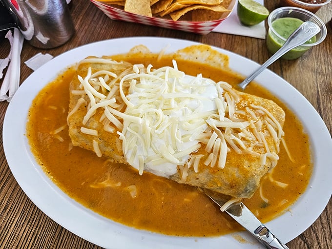 This wet burrito swimming in savory sauce and blanketed with melted cheese isn't just comfort food—it's the culinary equivalent of a warm hug.