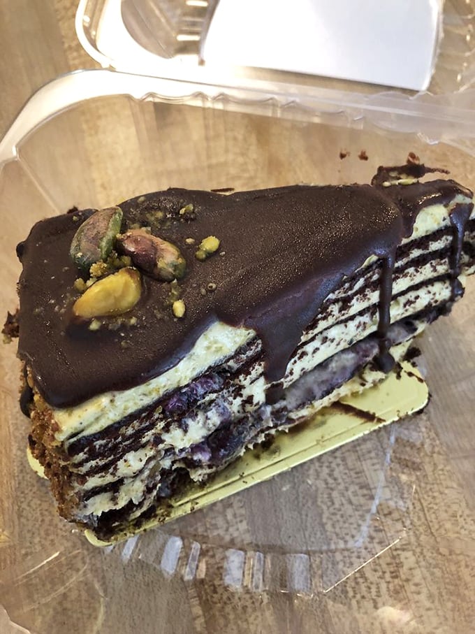 Layers upon layers of chocolate decadence topped with pistachios. This cake doesn't just satisfy cravings—it creates entirely new ones.