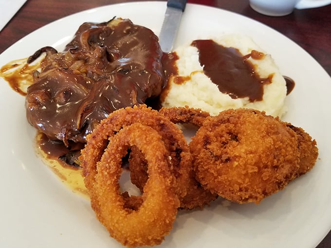 Comfort food doesn't get more comforting than this chopped steak smothered in gravy, with mashed potatoes and those perfectly golden onion rings.