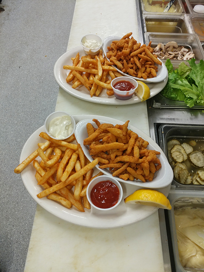 Golden clam strips and crispy fries—the kind of seafood platter that makes you wonder why you ever eat anything else at the coast.