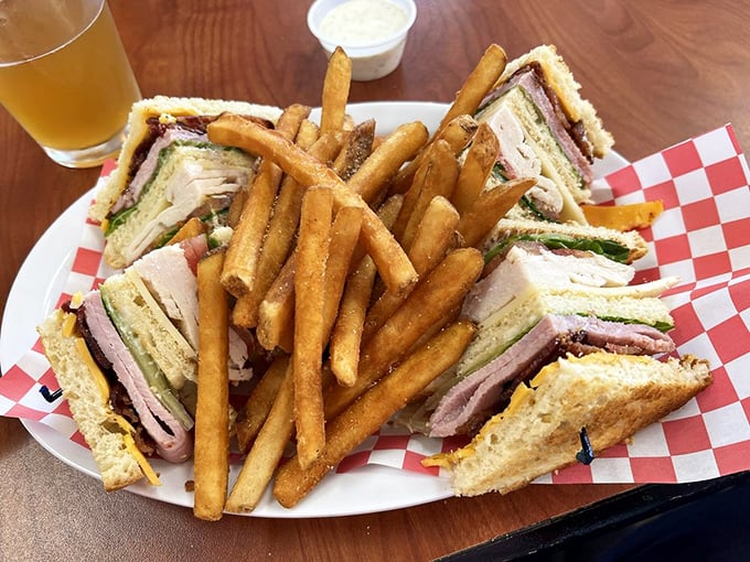 The club sandwich—civilization's perfect portable meal. Three layers of bread creating the high-rise apartment building that delicious ingredients dream of living in.