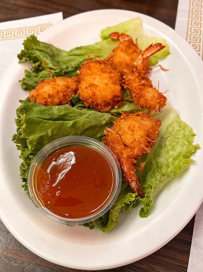 Golden coconut shrimp that crunch like autumn leaves, served with a sweet sauce that makes you consider drinking it straight.