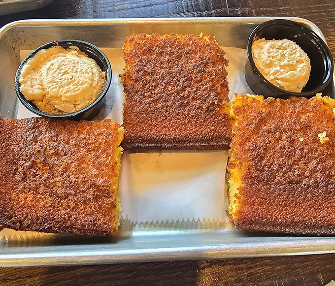 Cornbread so perfectly crusted it should have its own Instagram account. Those dipping sauces aren't just accessories—they're essential companions on this flavor journey.