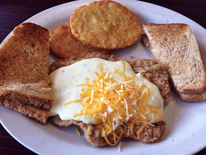 Country fried steak crowned with creamy gravy and melted cheese – the kind of hearty plate that renders dinner completely unnecessary.