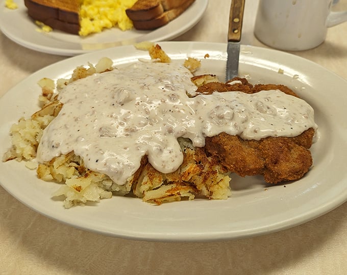 Country fried steak smothered in pepper gravy—comfort food that hugs your insides. The kind of breakfast that fuels both body and soul for whatever the day brings.