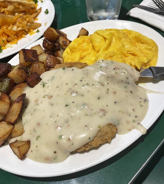 Country fried steak smothered in pepper gravy with those home-style potatoes—comfort food that makes you want to hug your plate before devouring it.