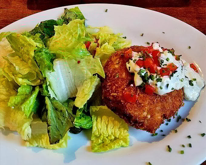 The Maryland-style crab cake doesn't hide behind fillers—it proudly showcases sweet lump crabmeat topped with fresh pico and a dollop of heaven.