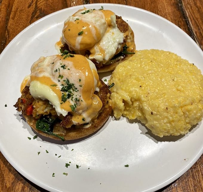 These Benedict eggs aren't just poached—they're pampered, then perched atop crab cakes with hollandaise that would make a French chef weep with joy.