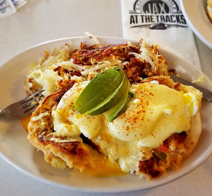 Eggs Benedict gets the California treatment with fresh avocado and perfectly poached eggs – breakfast architecture at its finest.