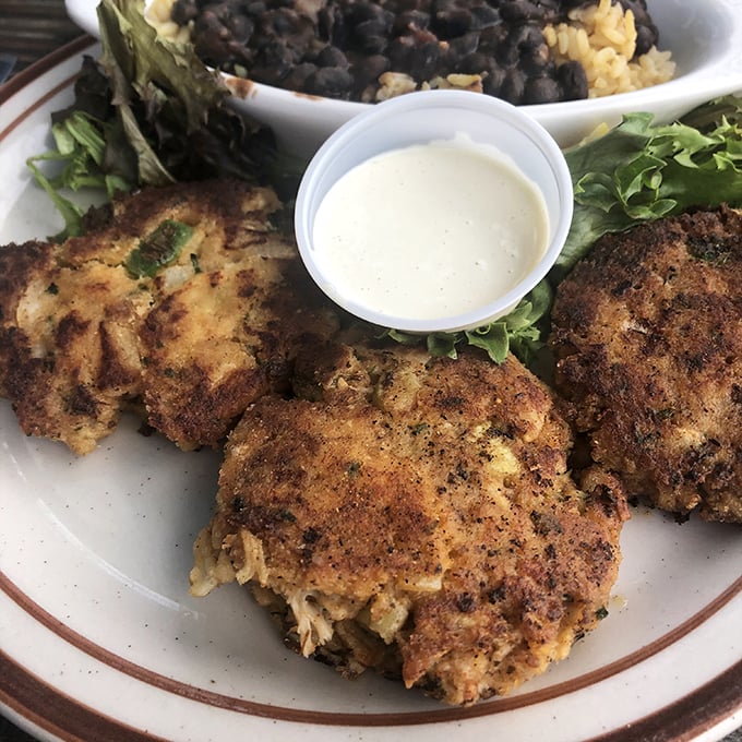 Crab cakes that actually deserve the name—mostly crab, barely bound, perfectly bronzed. The kind that make you wonder why you ever settled for less.