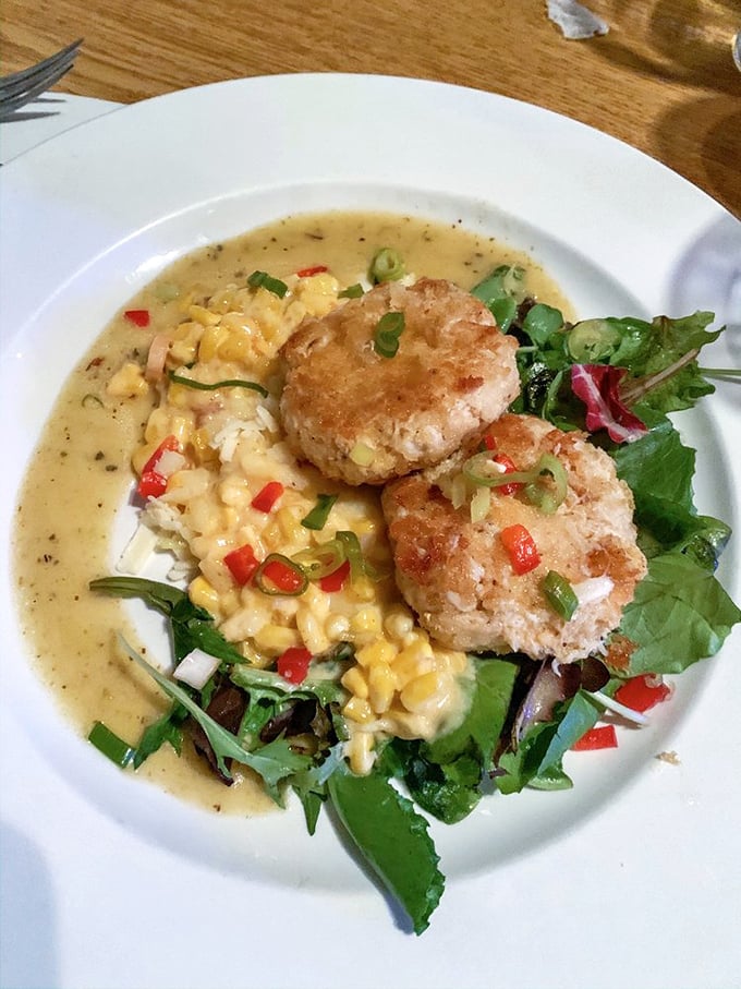 These crabcakes aren't just sitting on creamed corn—they're holding court, surrounded by their loyal subjects of microgreens and red pepper confetti.