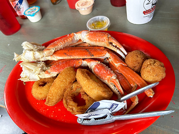 Snow crab legs and onion rings sharing a plate like the odd couple of seafood. Those crackers aren't just tools—they're the keys to unlocking oceanic treasure.