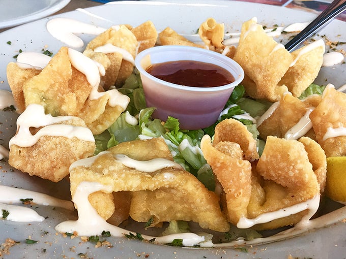 Crispy little pouches of joy drizzled with sauce. Like edible treasure chests where X marks the spot for your taste buds. 