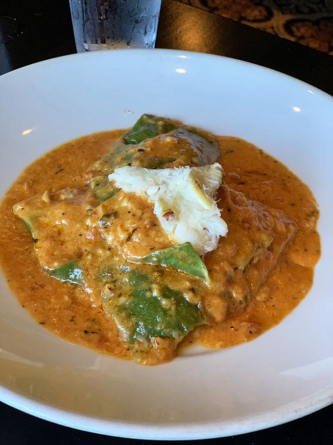 Not just fish in sauce, but a seafood sonnet—delicate white fish bathed in a creamy orange-hued sauce that whispers of spice and comfort in equal measure.