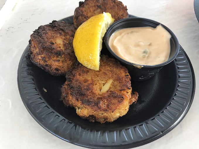 These golden-brown crab cakes aren't hiding behind fancy presentation—just pure, lump crabmeat with minimal filler and maximum flavor. The squeeze of lemon seals the deal.