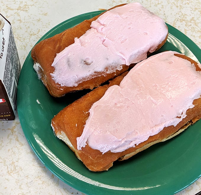 Pretty in pink and ready for their close-up. These cream-filled long johns don't just satisfy hunger – they're the dessert equivalent of a warm hug from your favorite aunt.