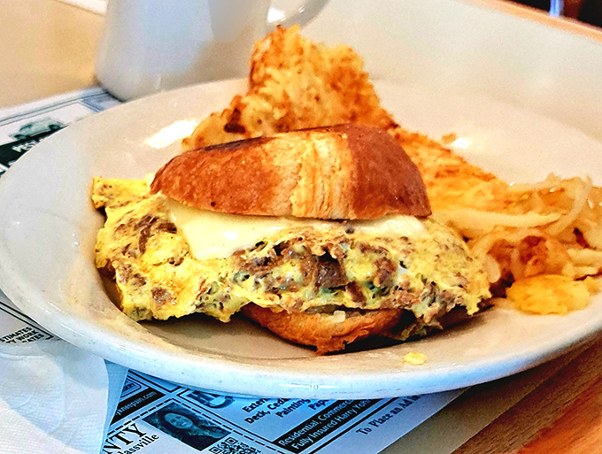 This sandwich isn't just breakfast, it's architecture—layers of egg, cheese, and goodness on a croissant foundation that would make Frank Lloyd Wright proud.